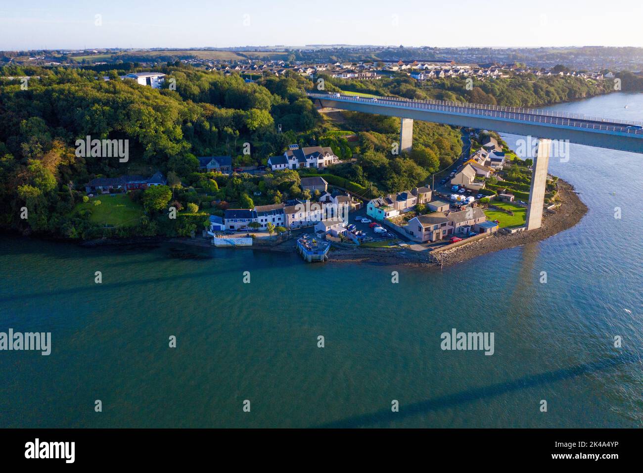 A bird's eye view of the Cleddau Bridge over residential buildings and ...