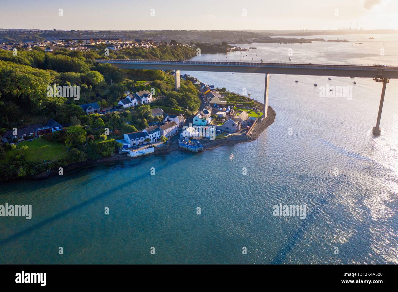A bird's eye view of the Cleddau Bridge over residential buildings and ...