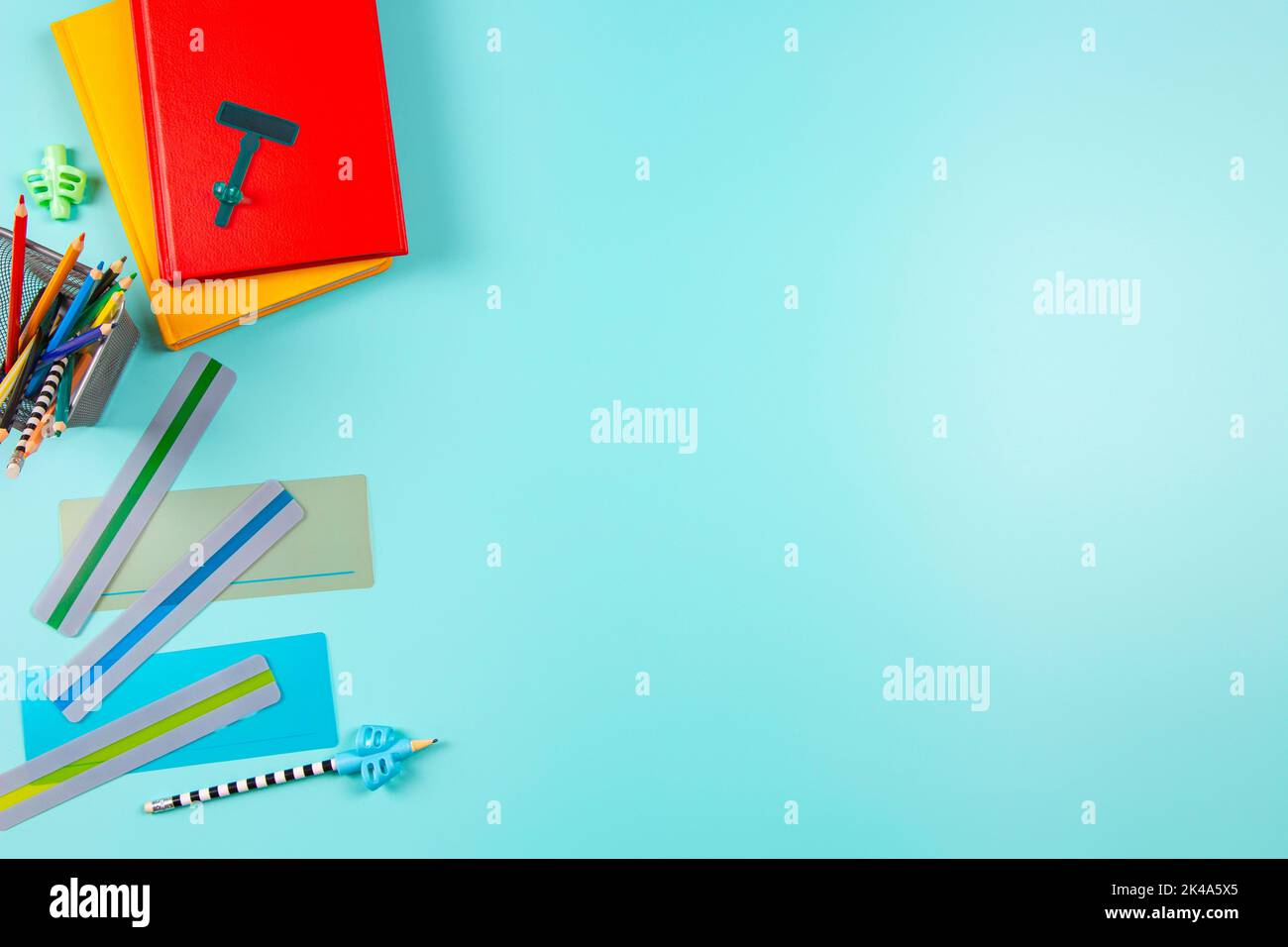 Top view to desk with books, colorful rulers overlay strips and school ...