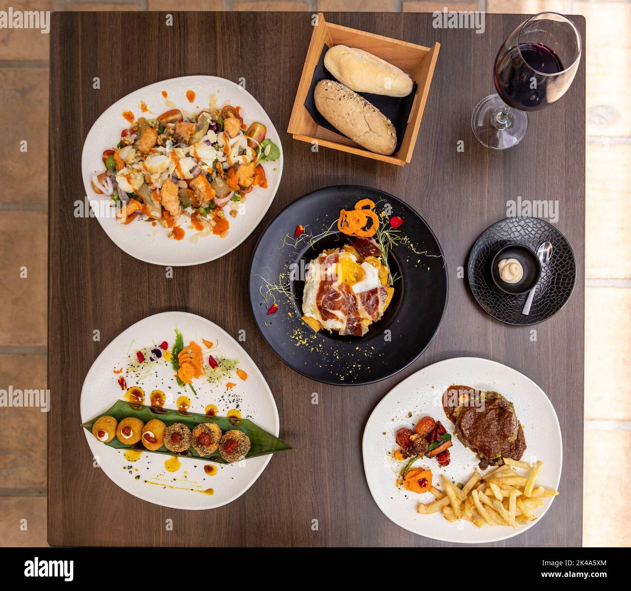 A vertical closeup of different types of dishes served in a restaurant ...