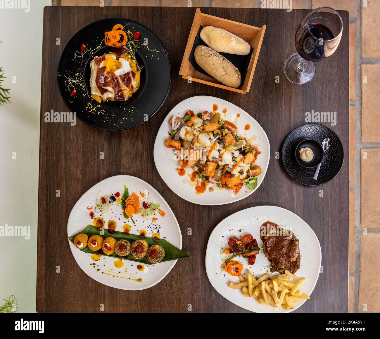 A vertical closeup of different types of dishes served in a restaurant ...