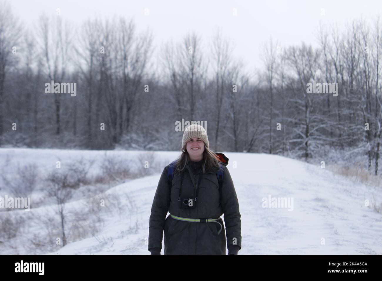 A Caucasian woman walking in the road covered with snow Stock Photo - Alamy