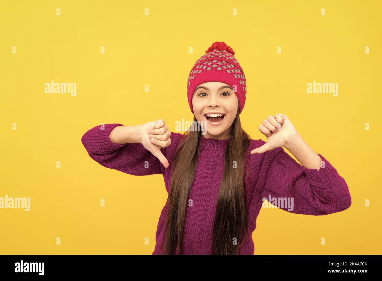 express positive emotion. point finger. surprised child in knitted hat ...