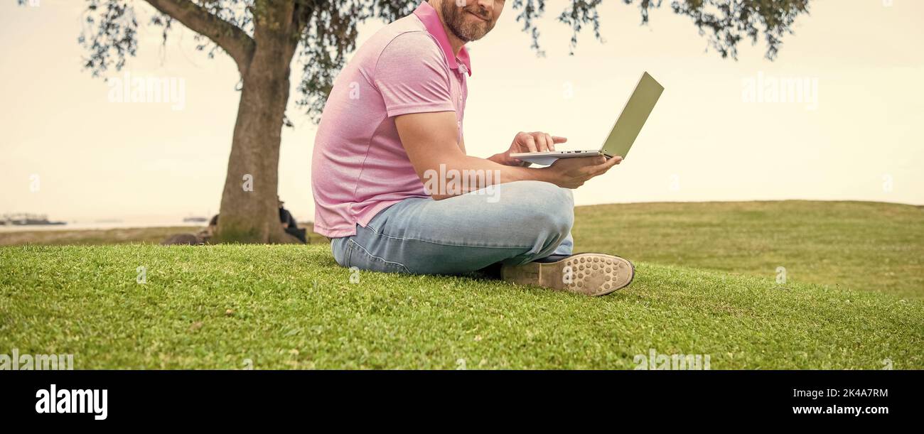 cropped freelance man post blog online sit on grass, email Stock Photo ...