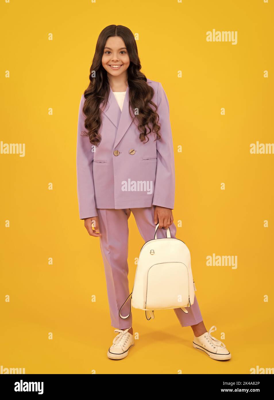 School girl in school uniform with school bag. Schoolchild teenager ...