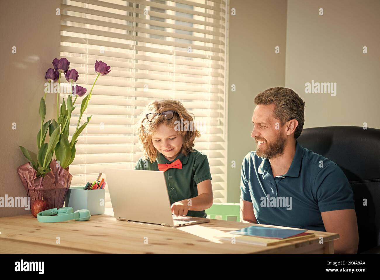 homeschooling and elearning. back to school. glad daddy and son in ...