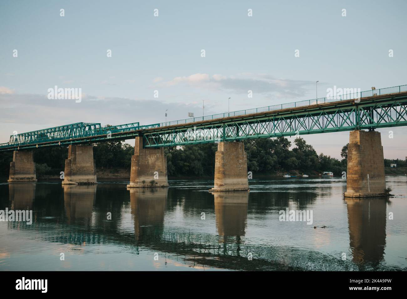 A metallic bridge over reflecting in the lake Stock Photo - Alamy