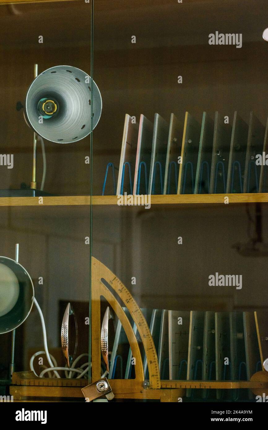 A vertical shot of the shelves with rulers and documents in a ...