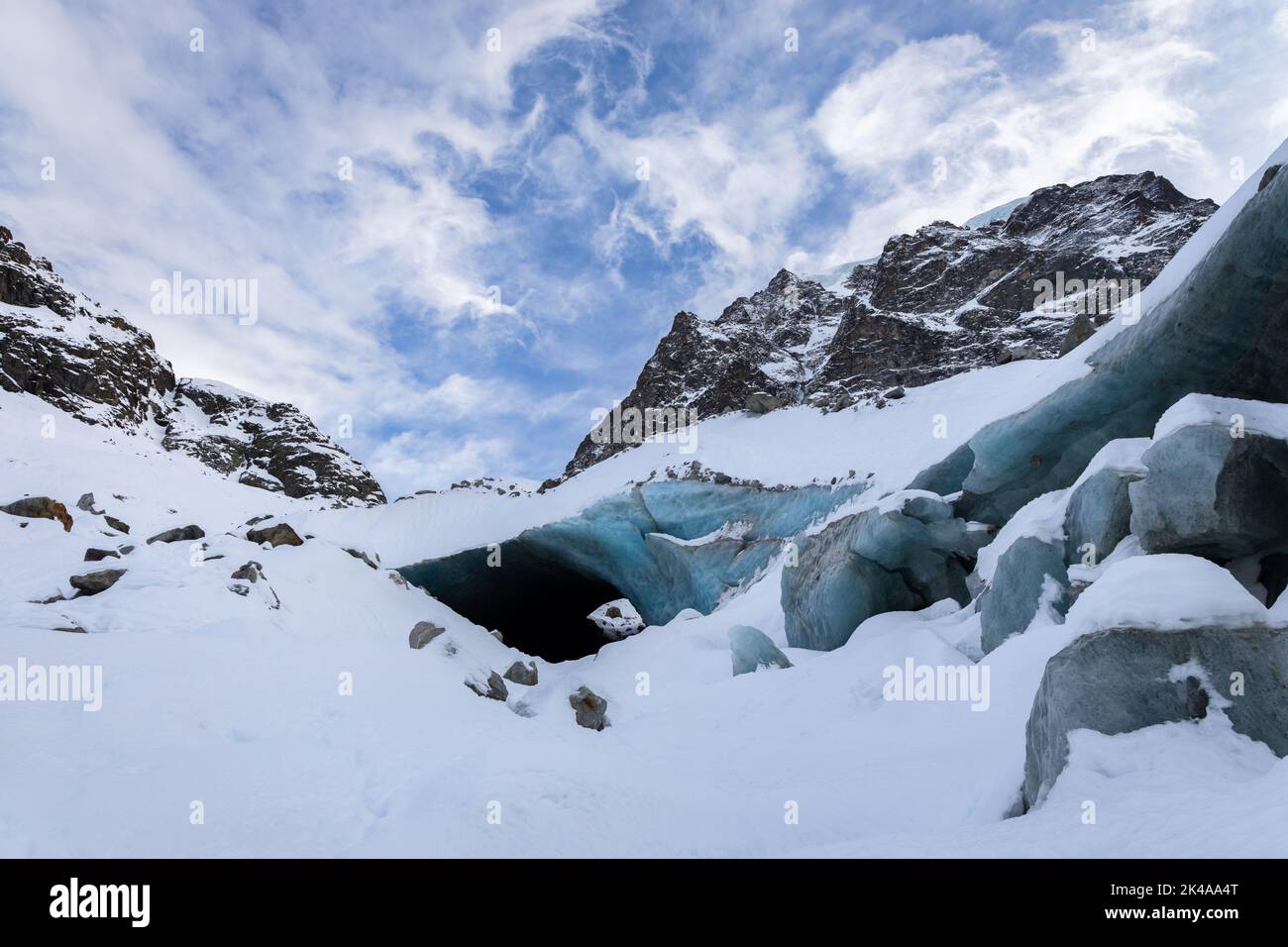Landscape mountain photo of Arolla glacier ice cave entrance covered by ...