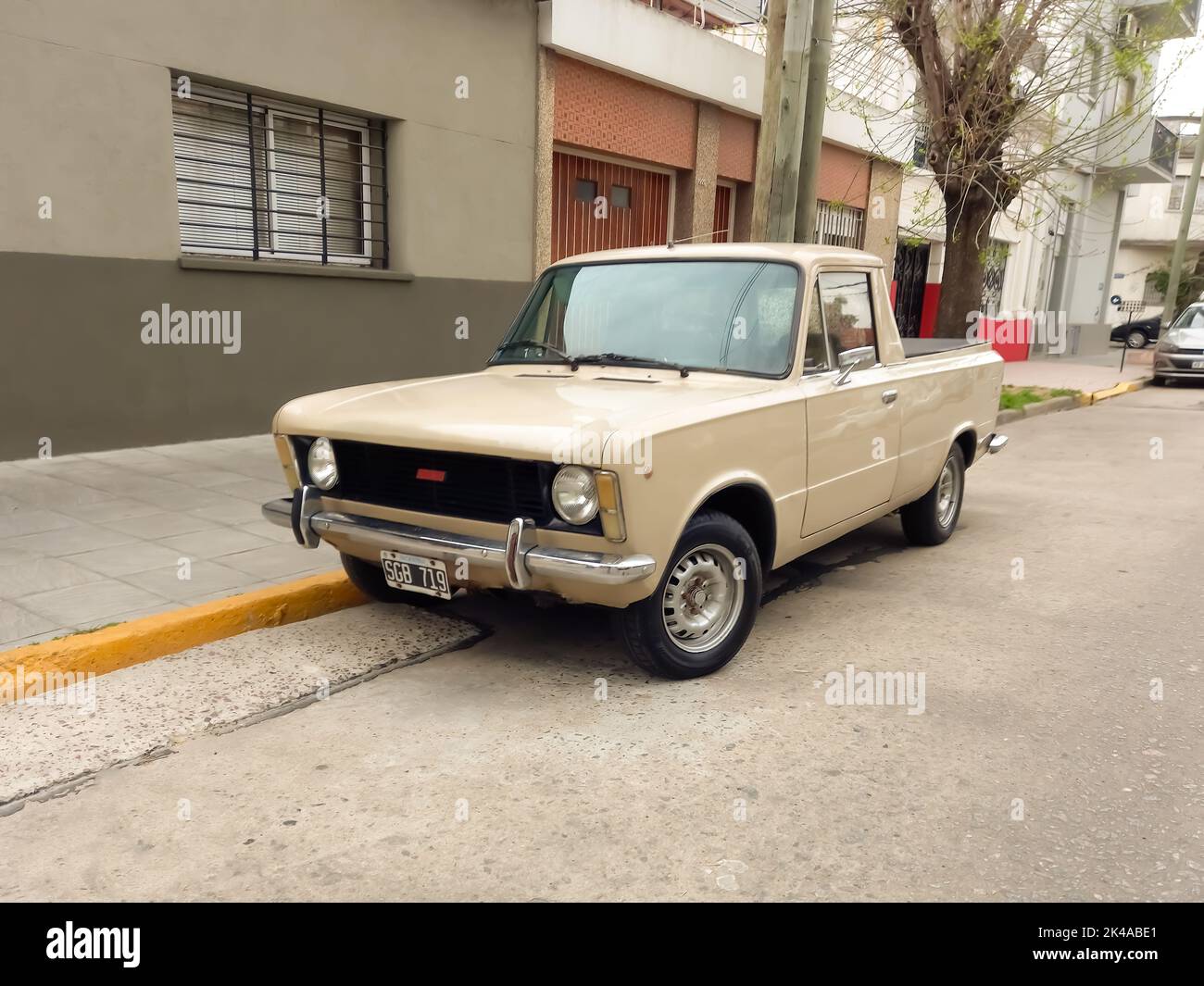 old beige 1970s Fiat 125 pickup parked in the street. Classic small ...