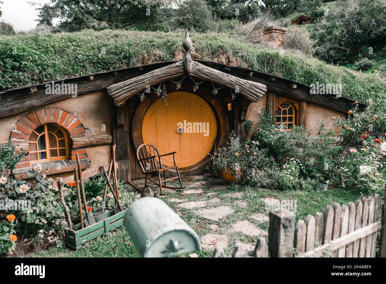 curious and pretty house buried in the mountain by the forest with ...