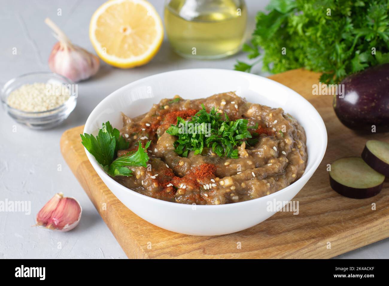 Baba ghanoush or eggplant hummus in white bowl on wooden board ...