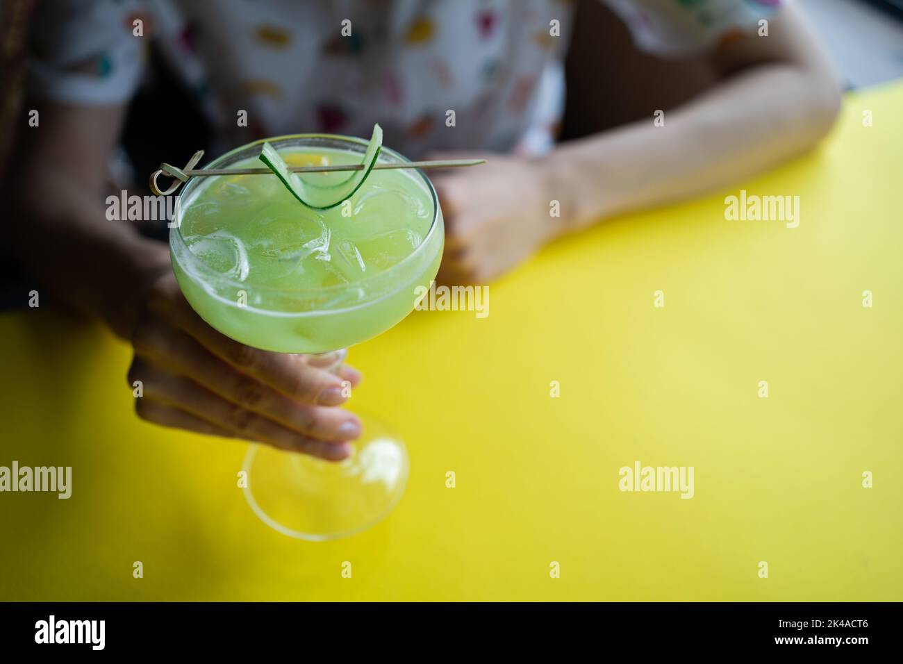 female drink green alcohol fruit cocktail with cucumber, lime, kiwi ...