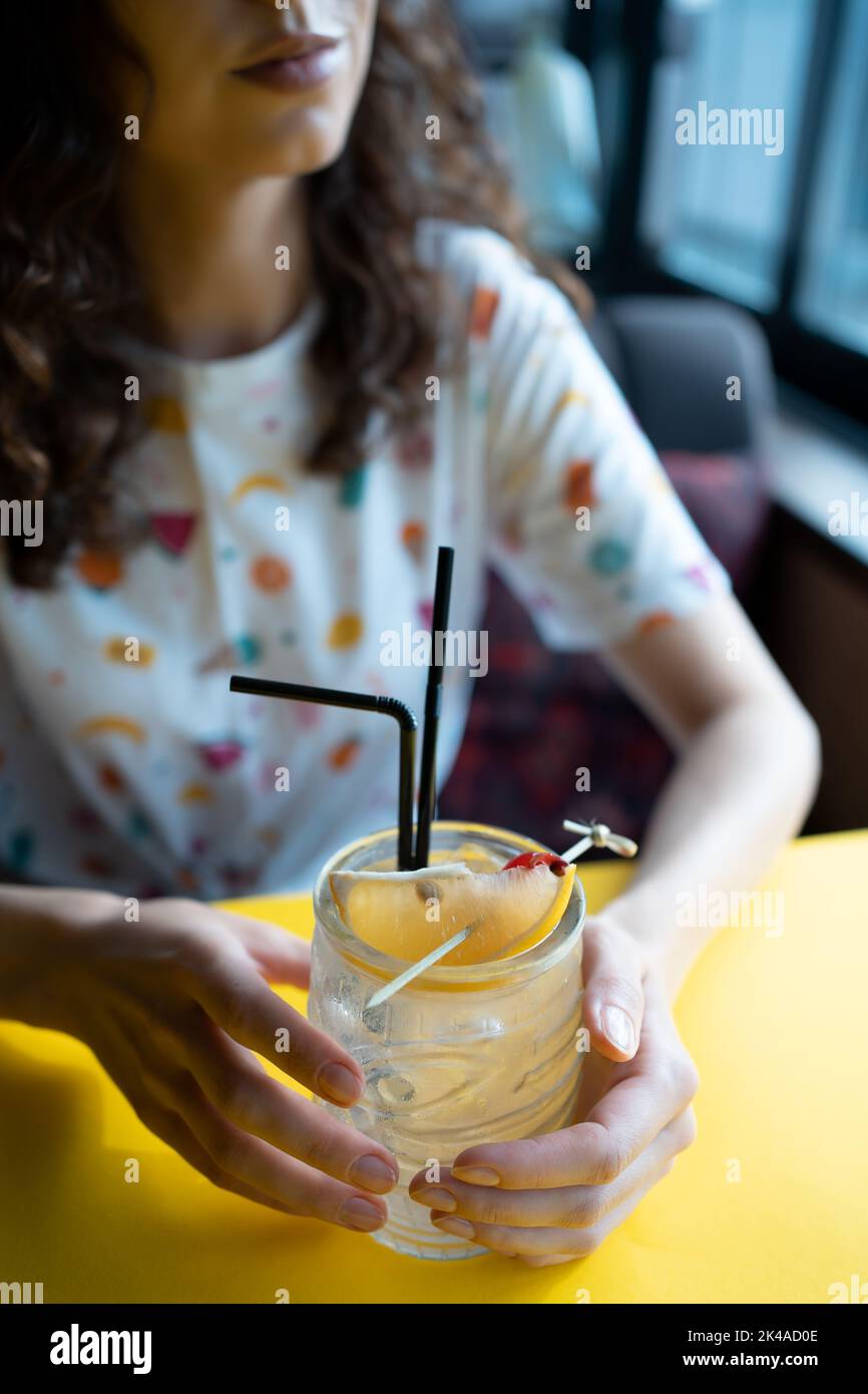 female drinking kamikaze cocktail tiki glass, vodka, triple sec, lemon ...