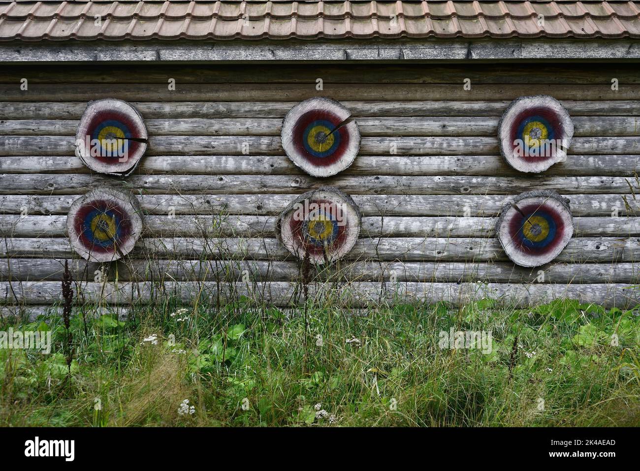 wooden round targets for archery on a log wall Stock Photo - Alamy