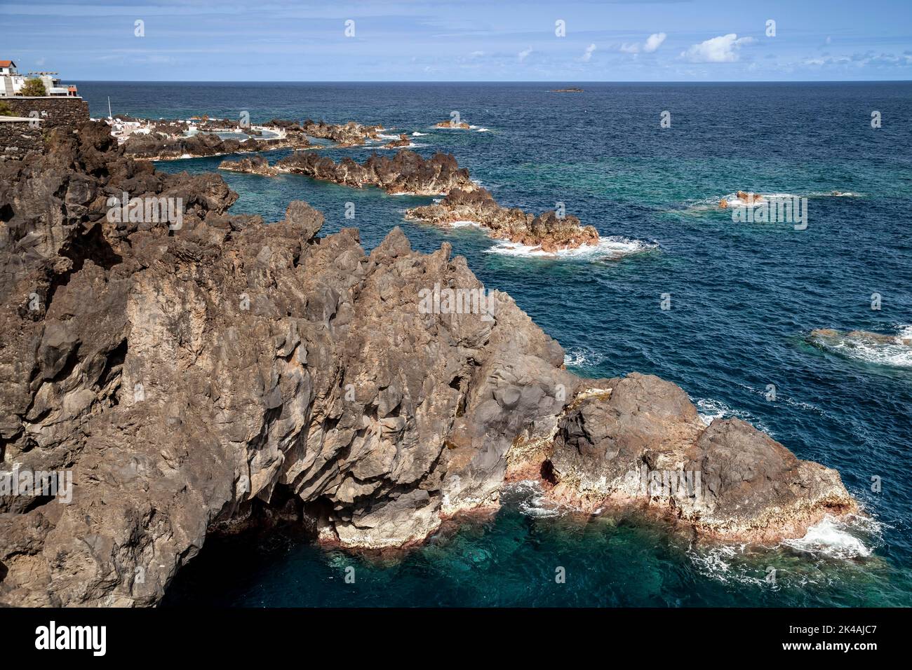 Rocky coast, in backround the Bathing complex, Natural Pools, paved ...