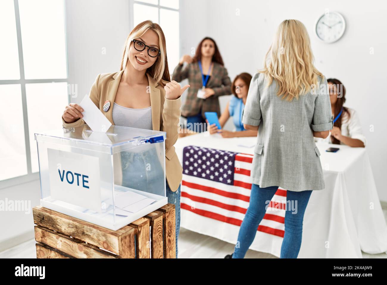 Group of young girls voting at democracy referendum pointing to the ...