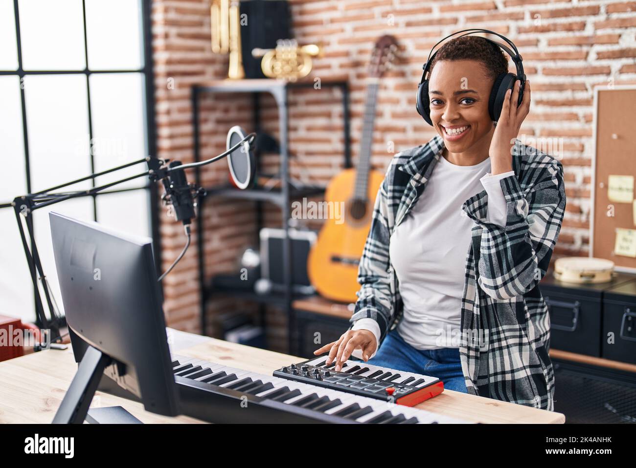African american woman musician having dj session at music studio Stock ...