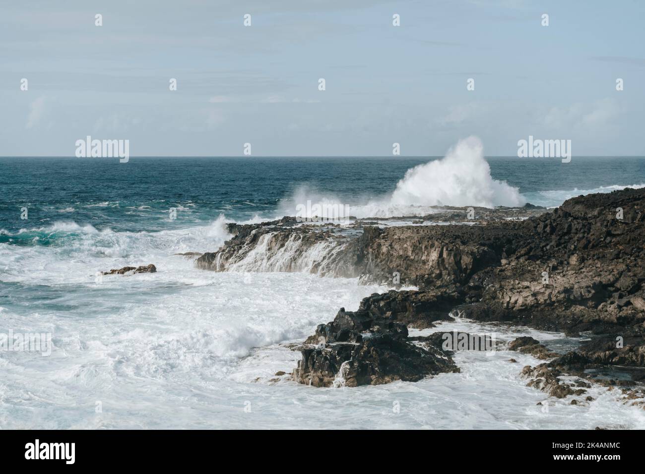 Water splash on black volcanic rocks of Tenesar, Lanzarote, Canary ...