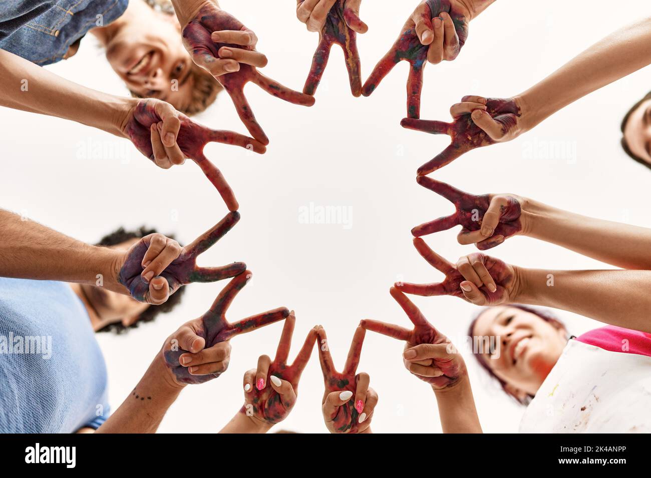 Group of young friends doing victory sign with fingers and hands ...