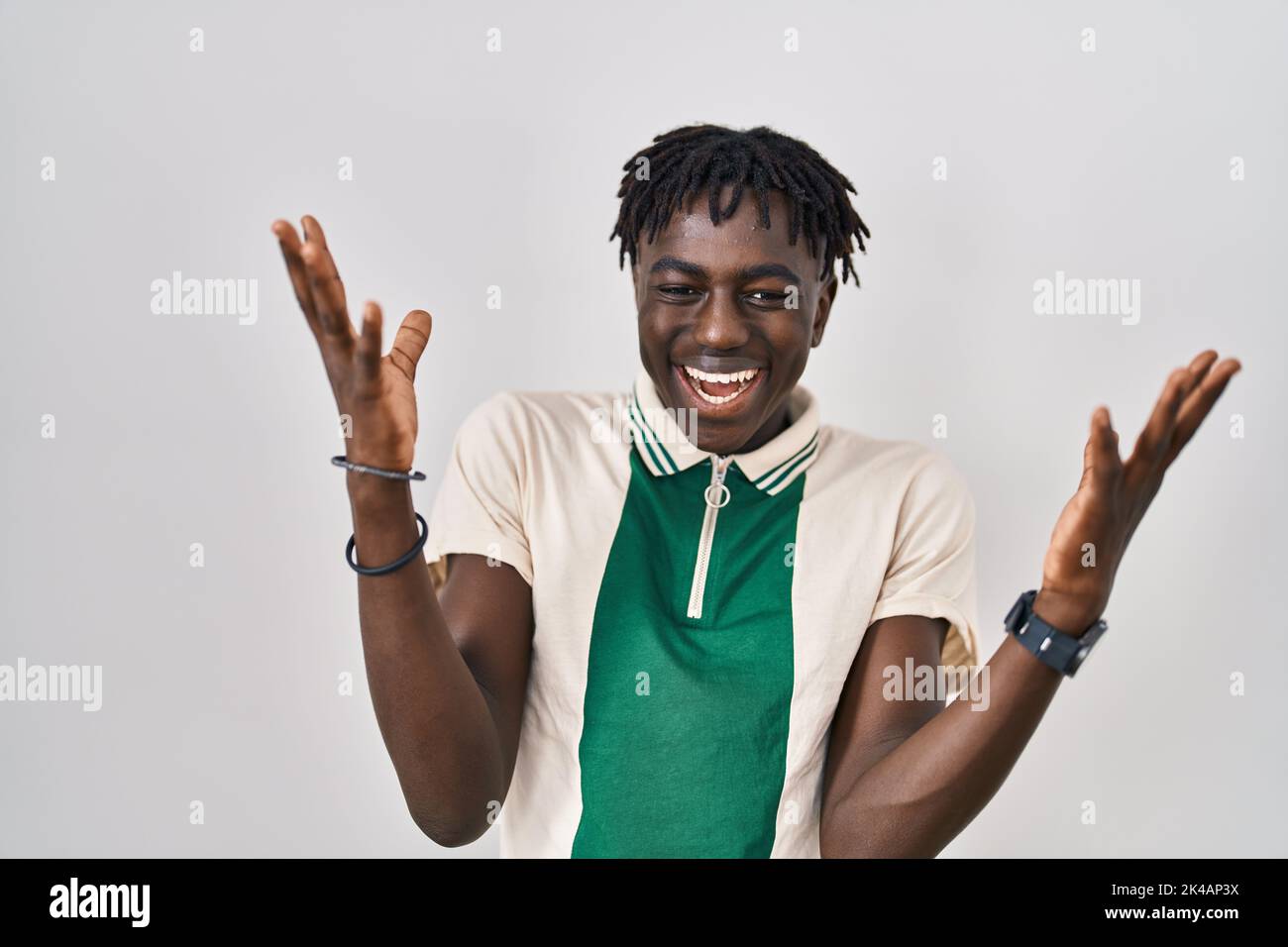 African man with dreadlocks standing over isolated background ...