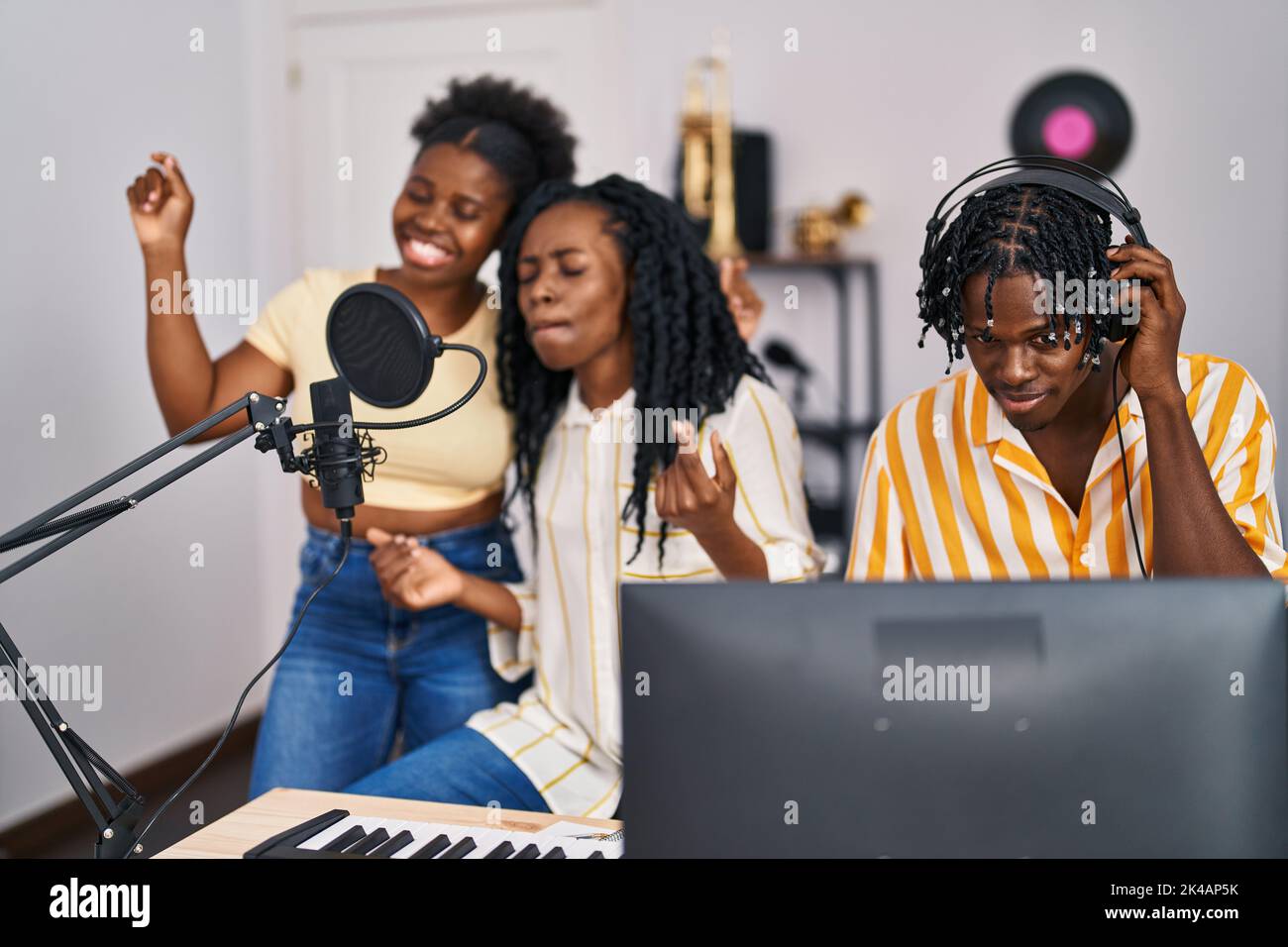 African american friends musicians group singing song at music studio ...