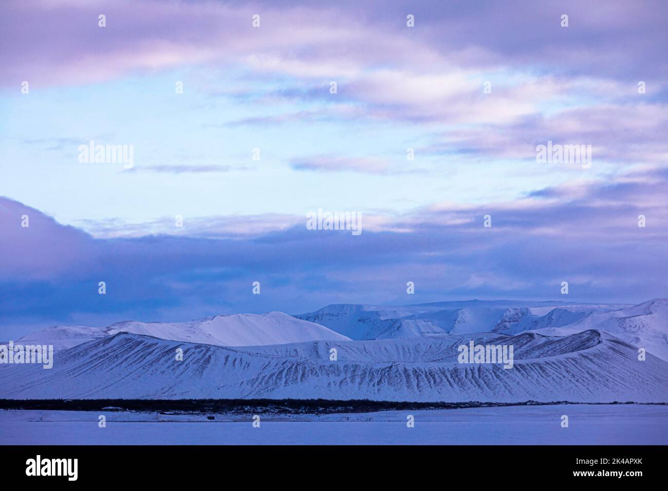 Snow-covered extinct volcano Hverfjall at blue hour, near Lake Myvatn ...