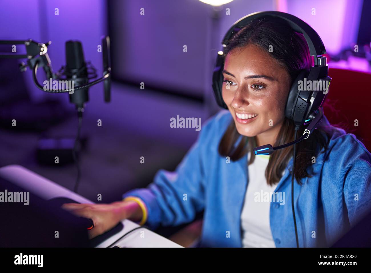 Young beautiful hispanic woman streamer playing video game using ...