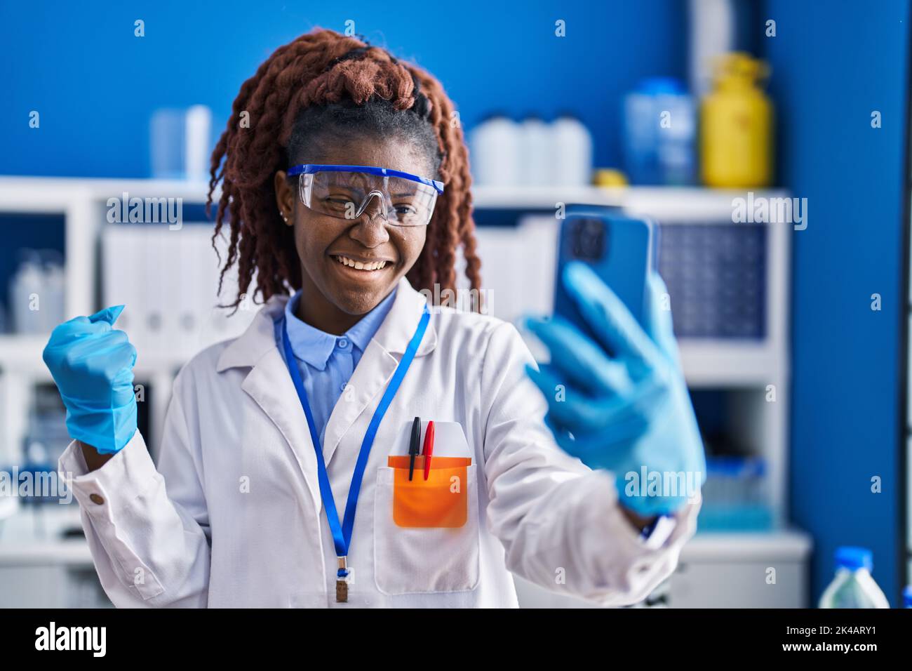 African woman working at scientist laboratory doing video call ...