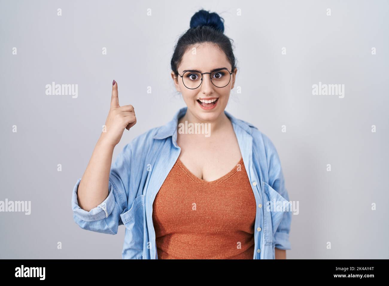 Young Modern Girl With Blue Hair Standing Over White Background 8361