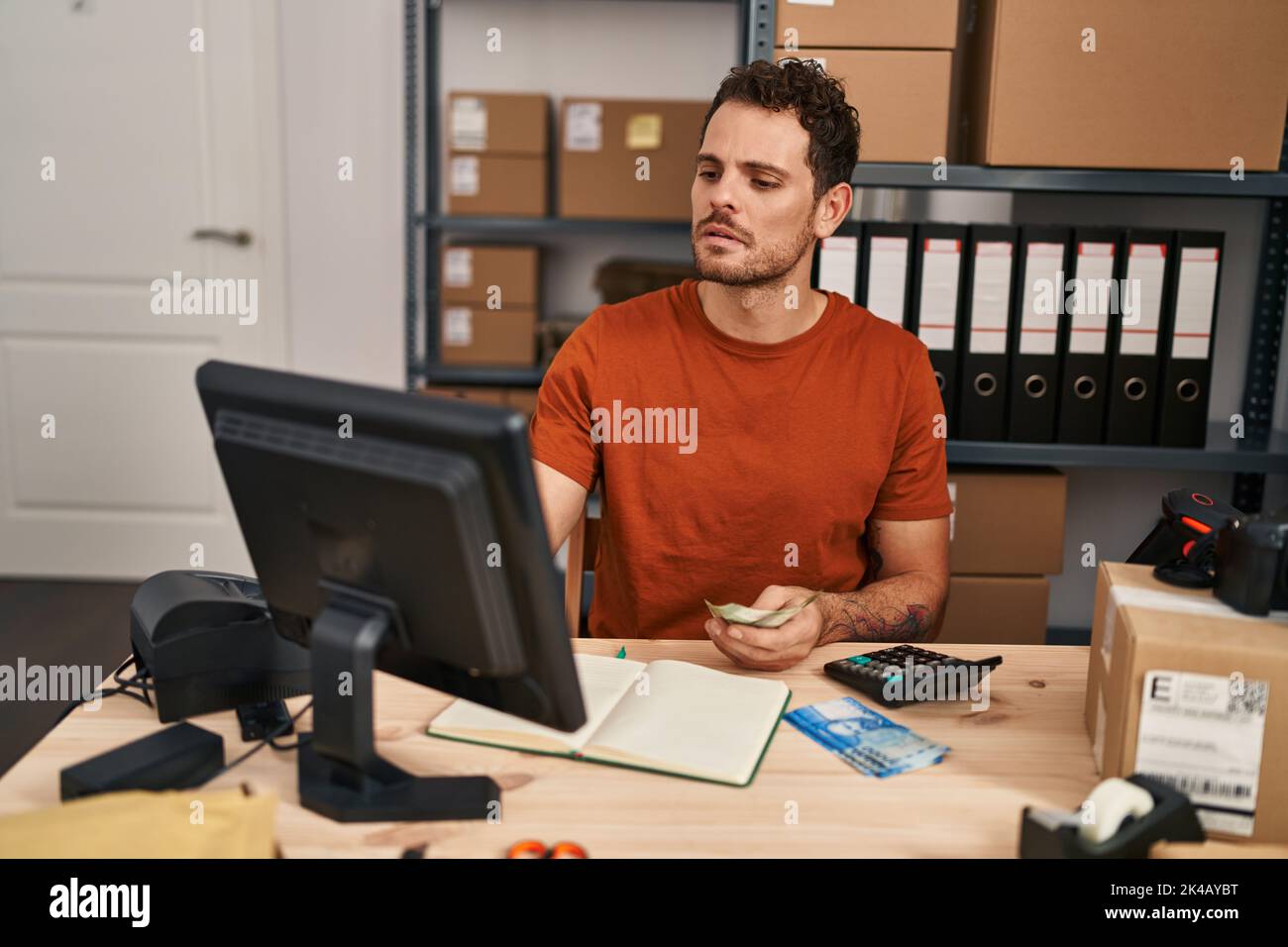 Young hispanic man ecommerce business worker counting chile pesos ...