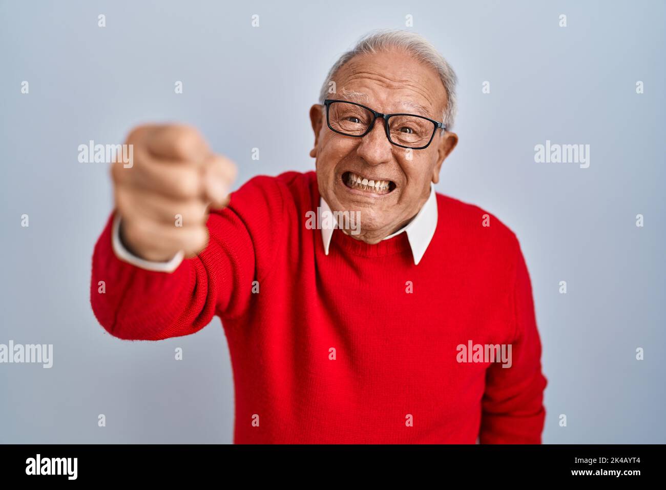 Senior man with grey hair standing over isolated background angry and ...