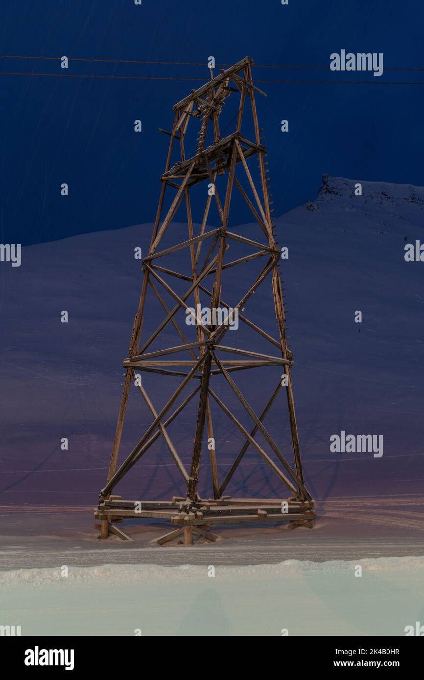 Decommissioned cable car timber structure towers in winter landscape ...