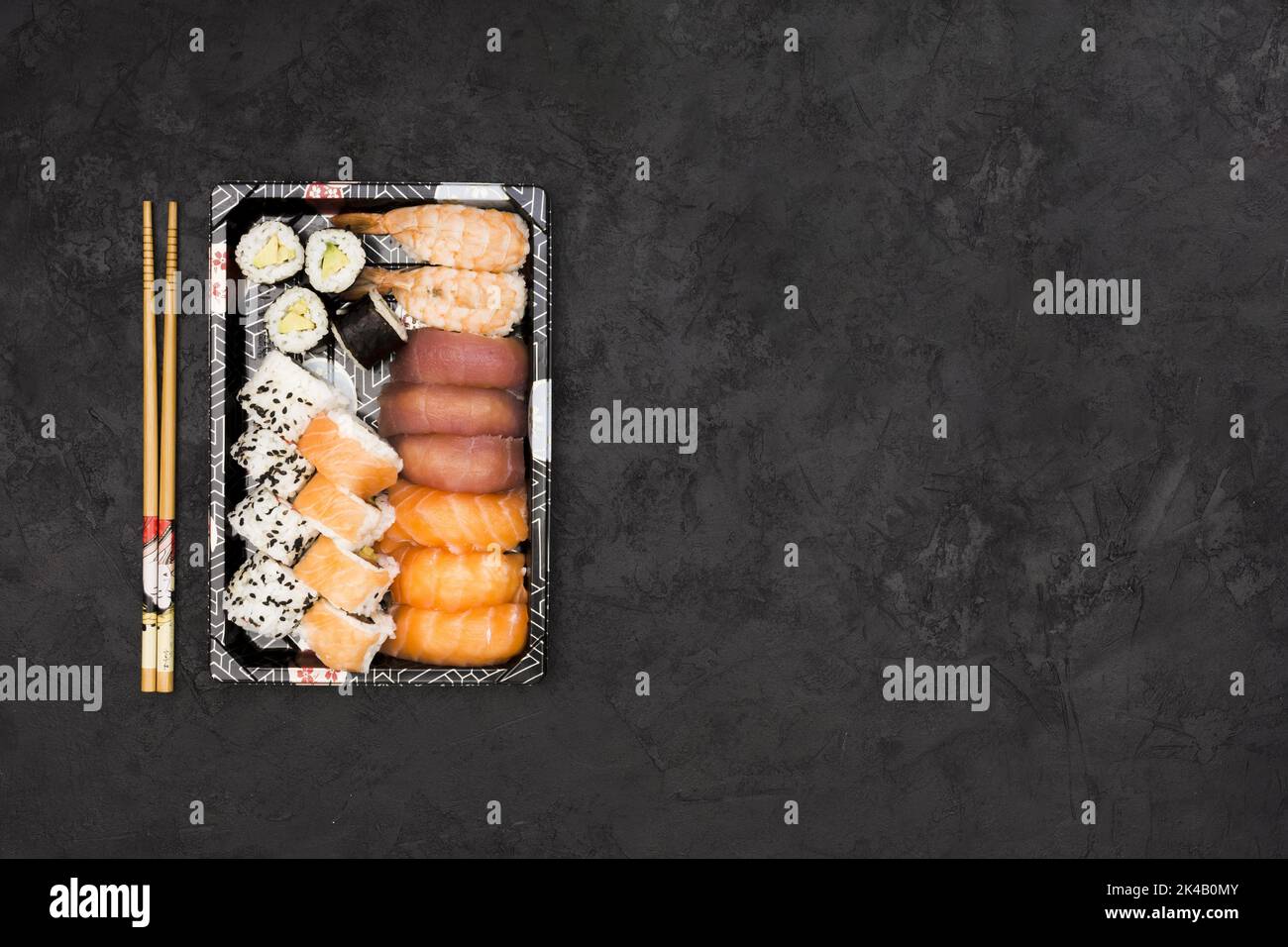 Set healthy asian rolls arranged tray sticks black background ...