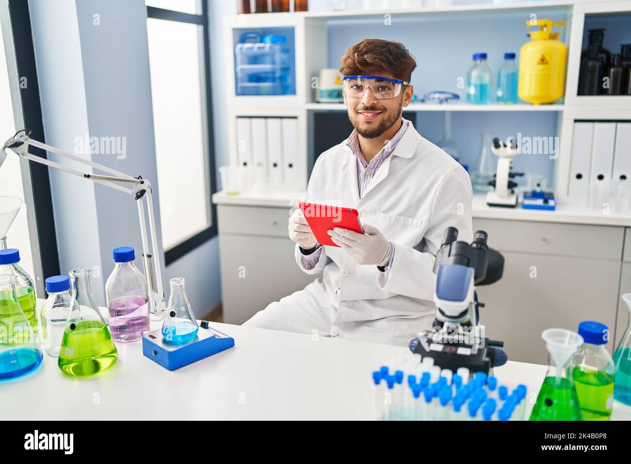Young arab man scientist using touchpad working at laboratory Stock ...