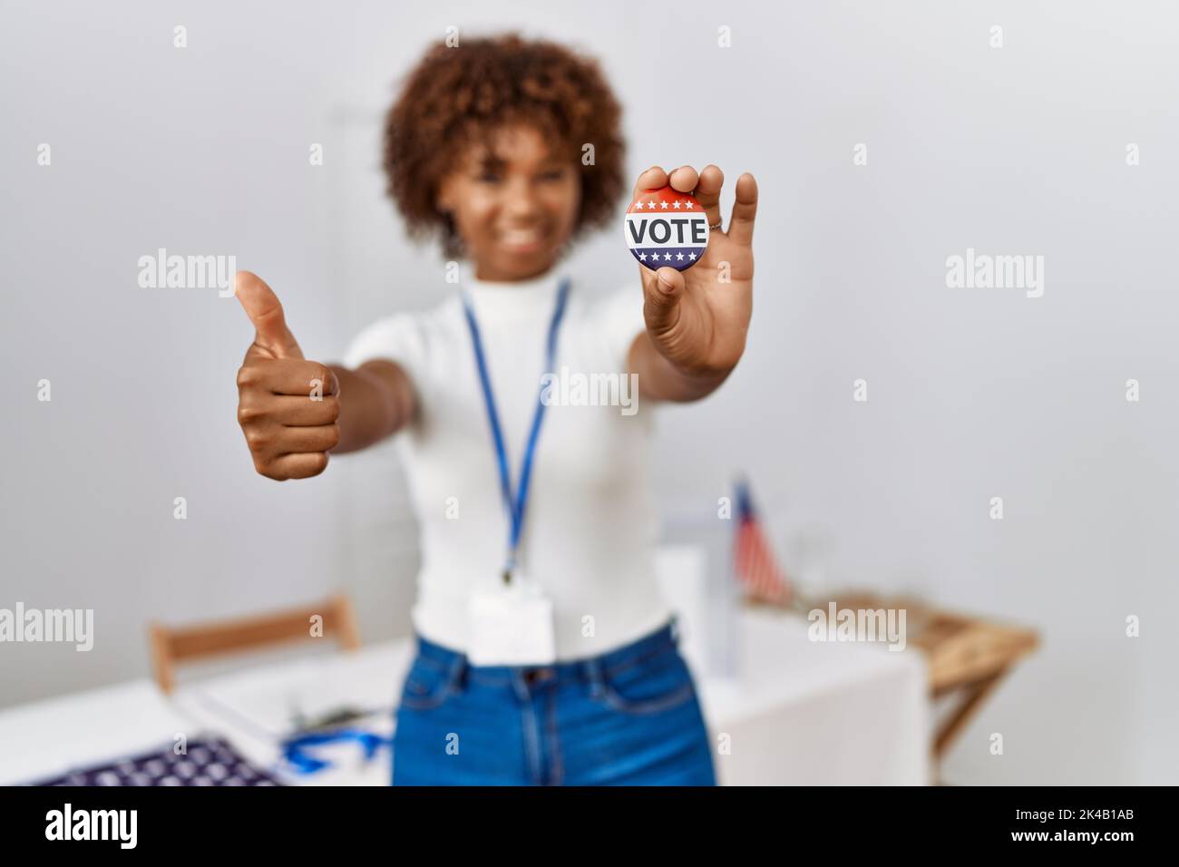 Young african american woman at political campaign election holding usa ...