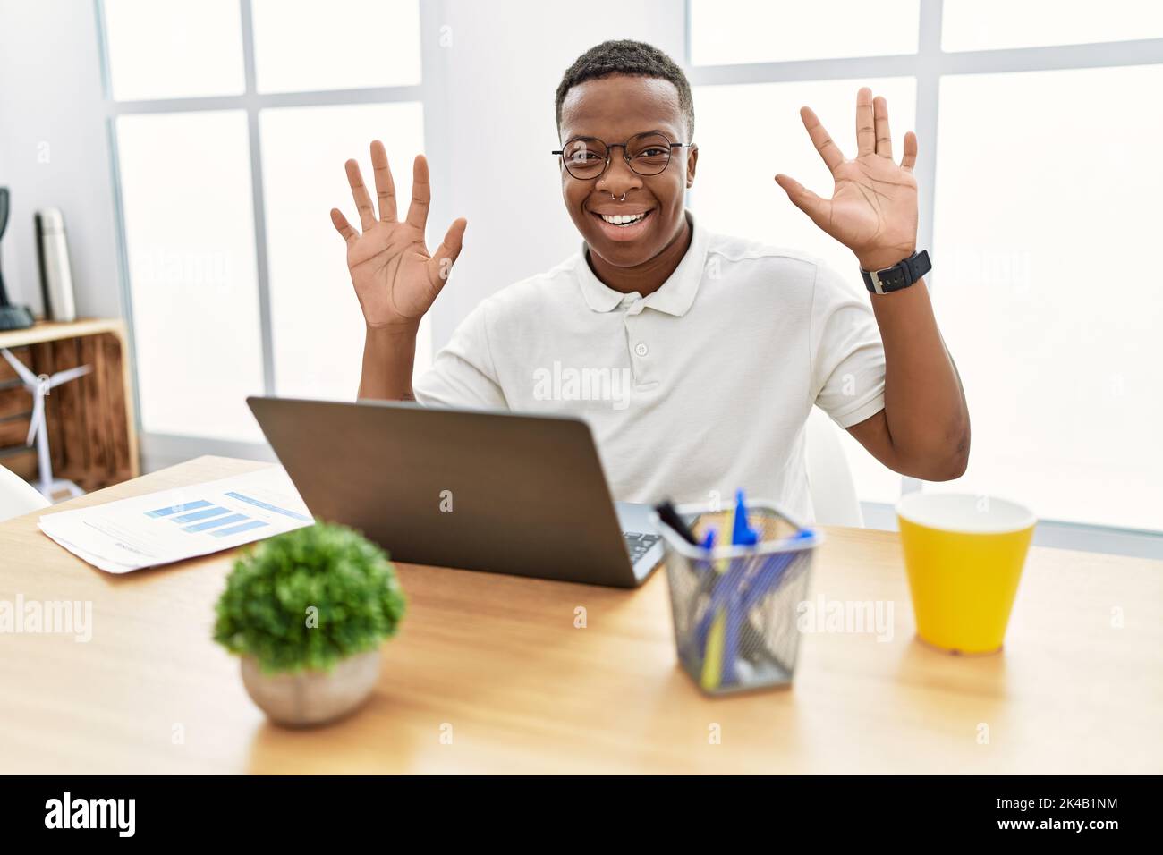 Young african man working at the office using computer laptop showing ...