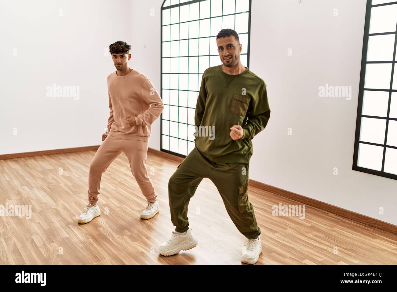 Two hispanic men couple dancers smiling confident dancing at sport ...