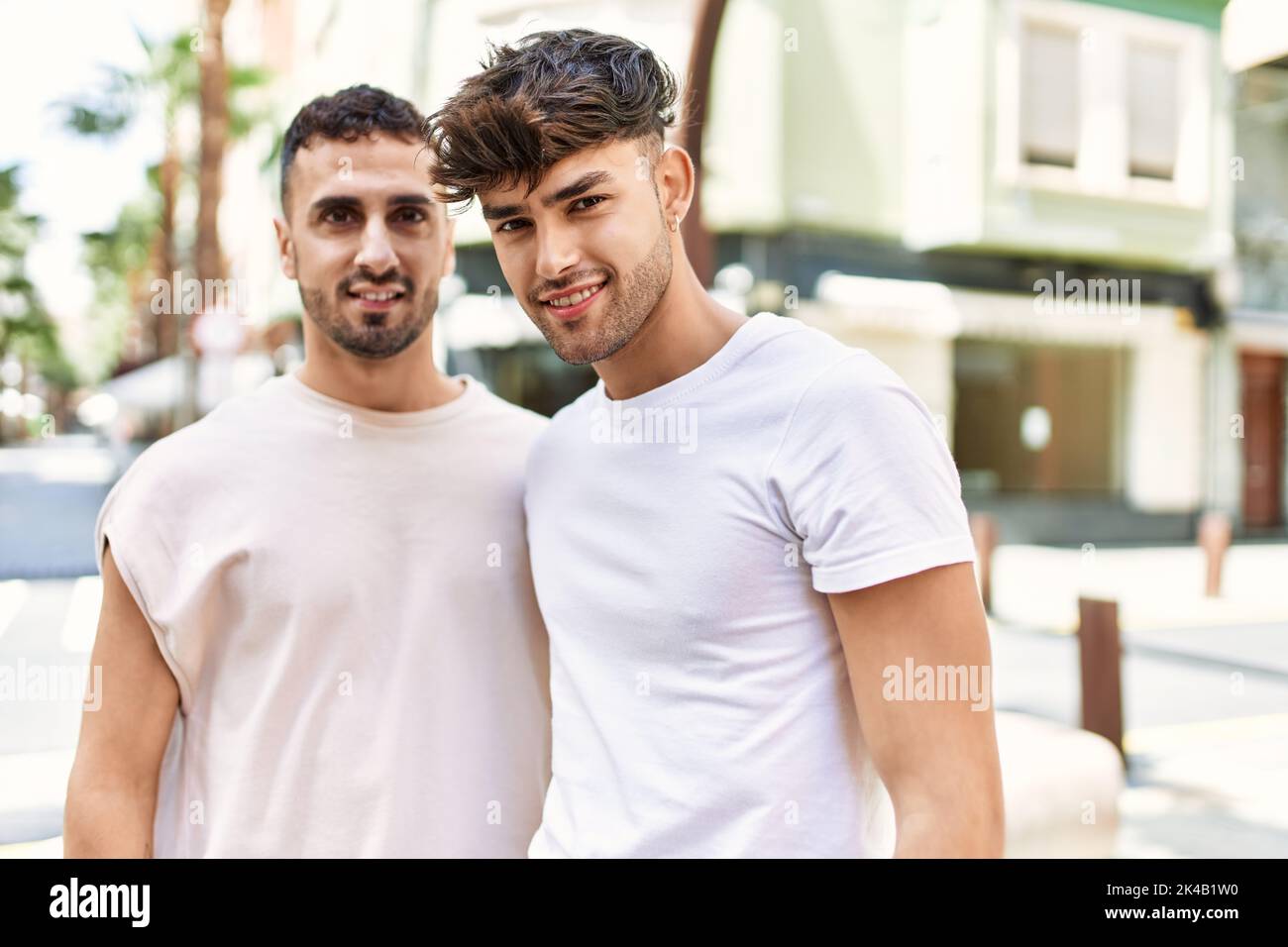 Two hispanic men couple smiling confident hugging each other standing ...