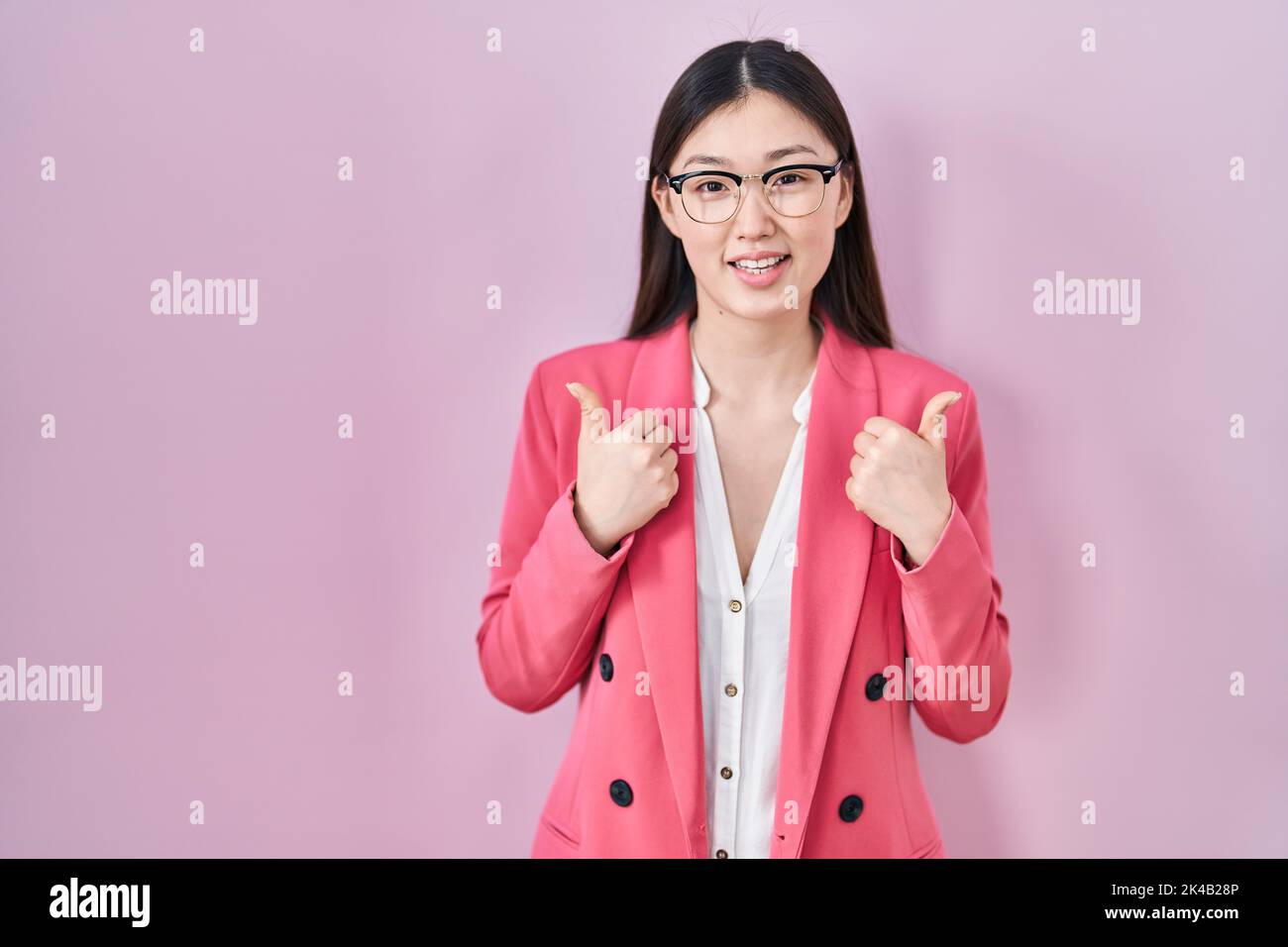 Chinese business young woman wearing glasses success sign doing ...
