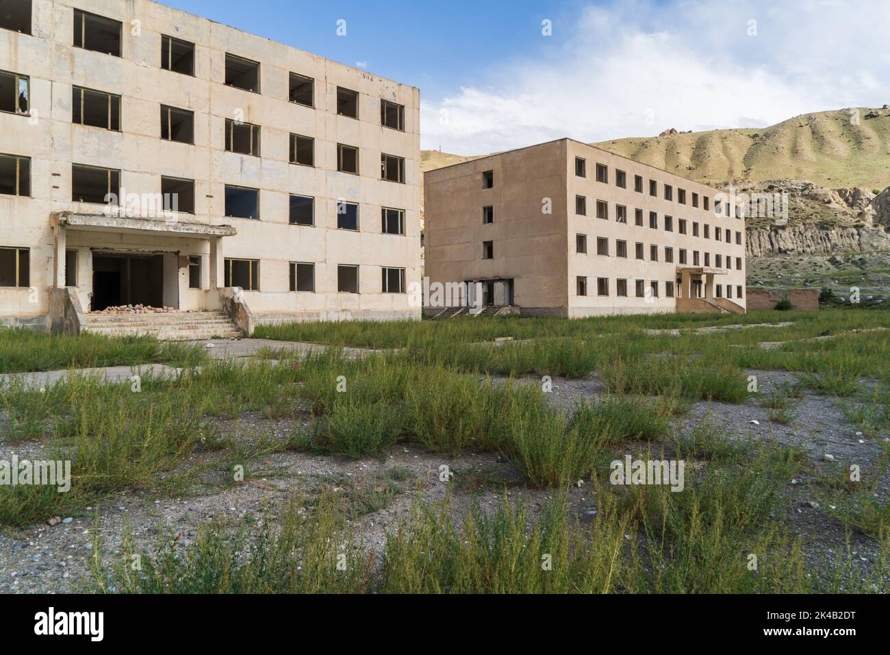 Unfinished abandoned apartment blocks in Enilchek mining town ...