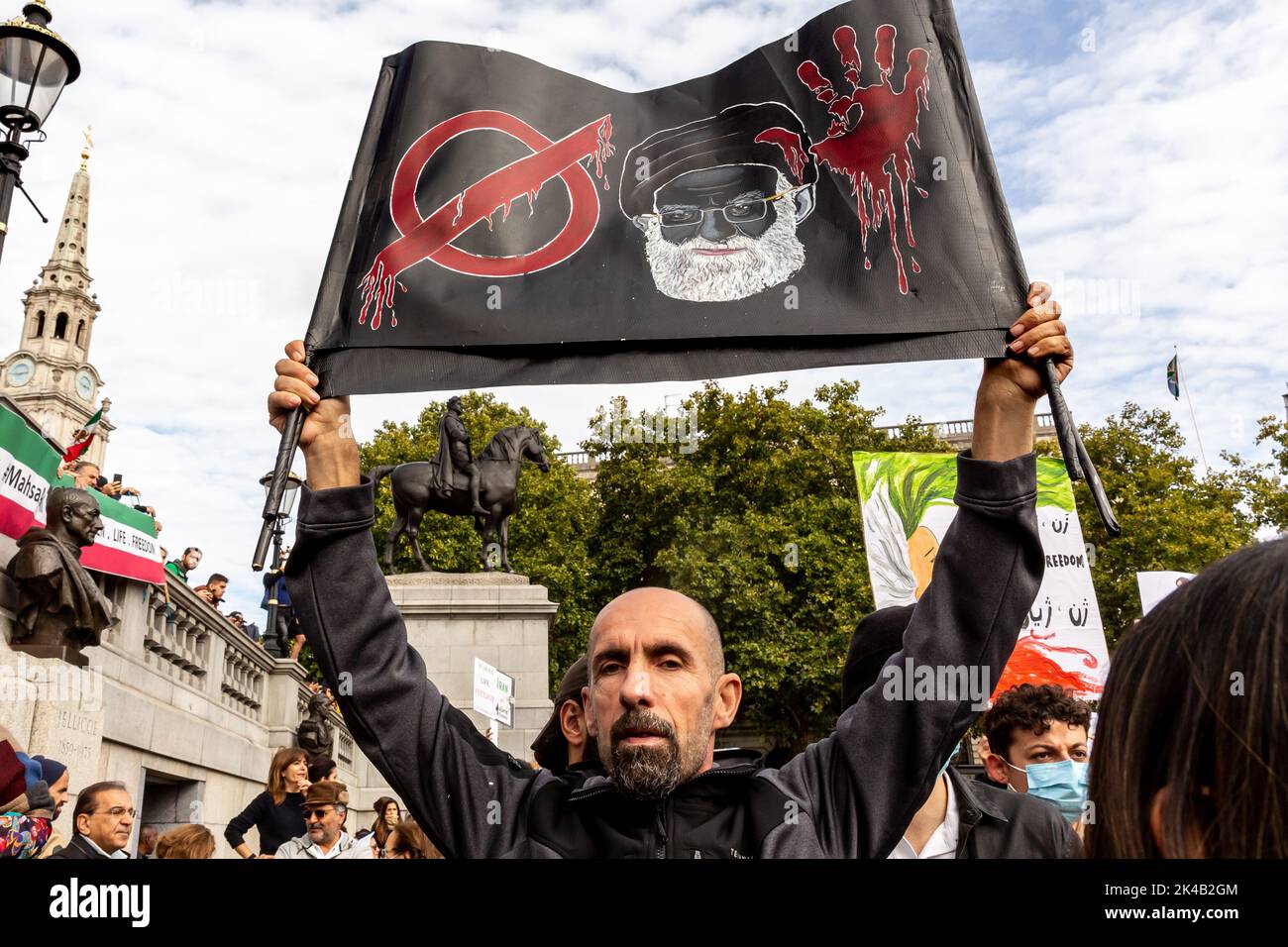 A man holds anti-regime banner during a demonstration in solidarity ...