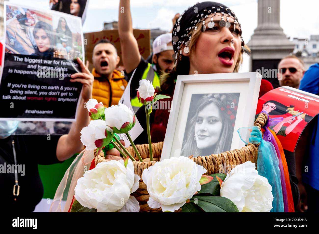 A demonstrators holds a picture of Mahsa Amini during a demonstration ...