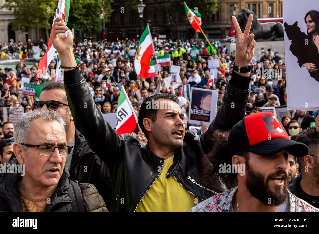 Protesters hold placards and flags during a demonstration in solidarity ...
