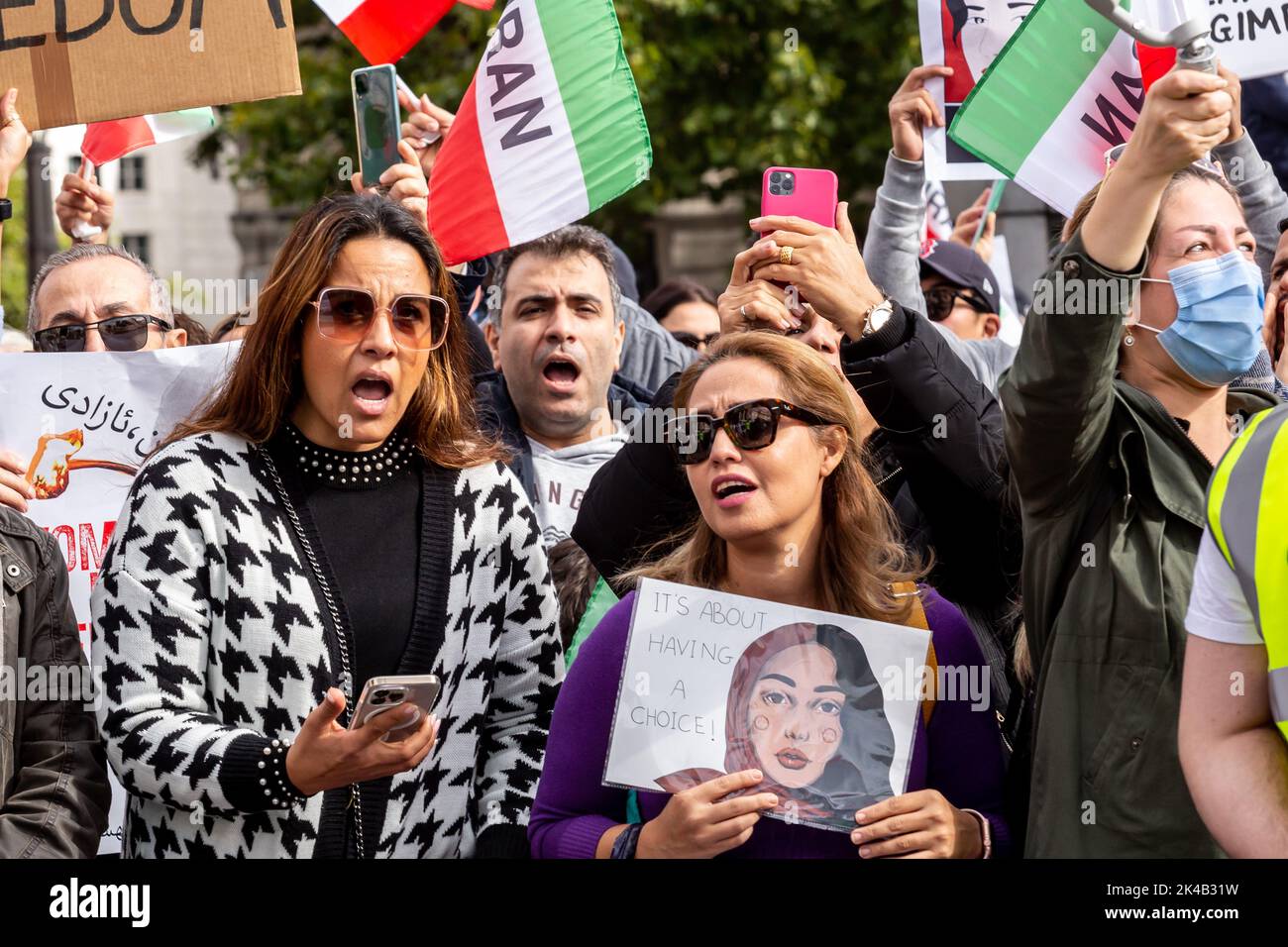 Protesters hold Iranian flags during a demonstration in solidarity with ...