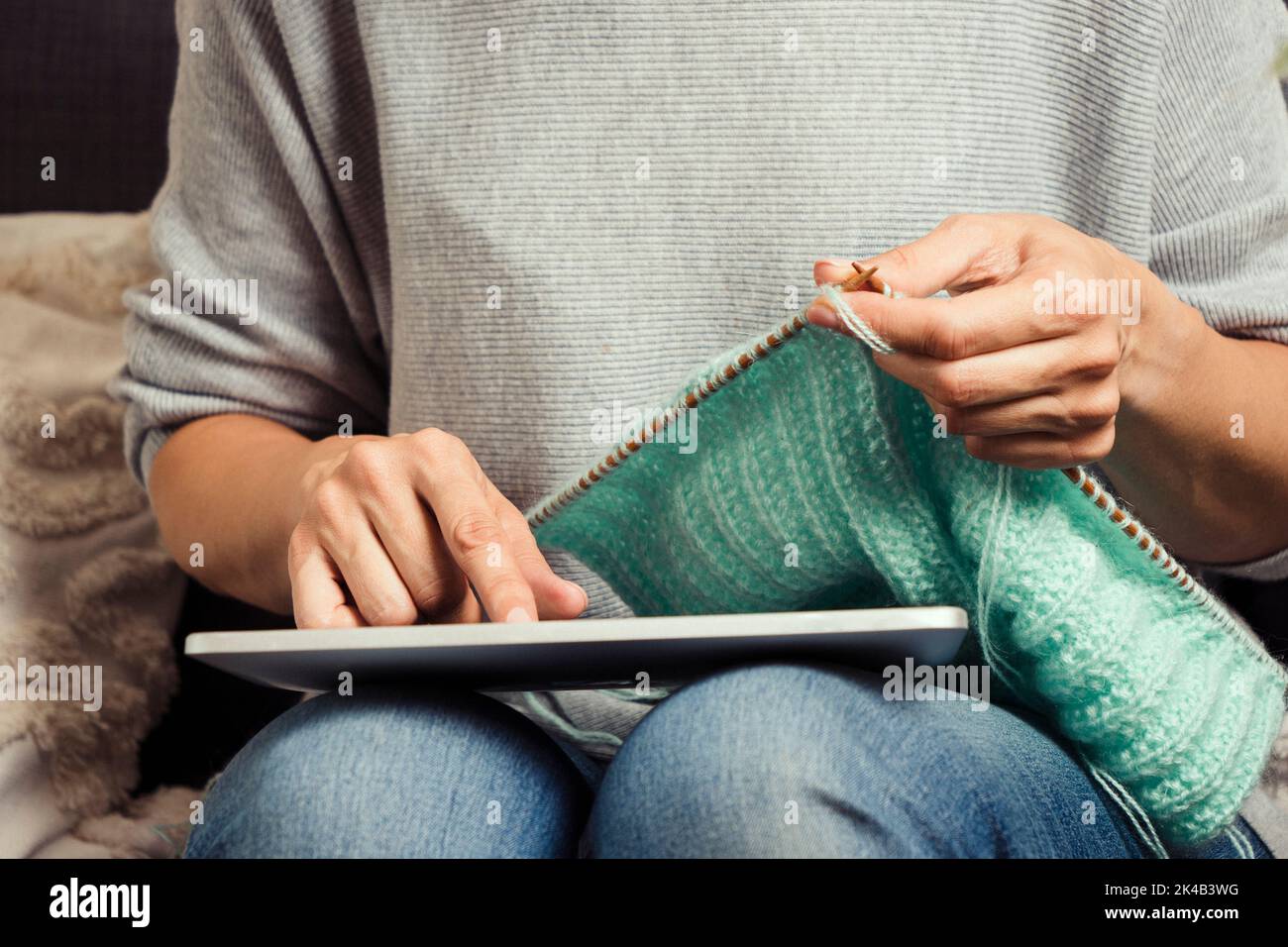 Woman knitting watching video on hi-res stock photography and images ...