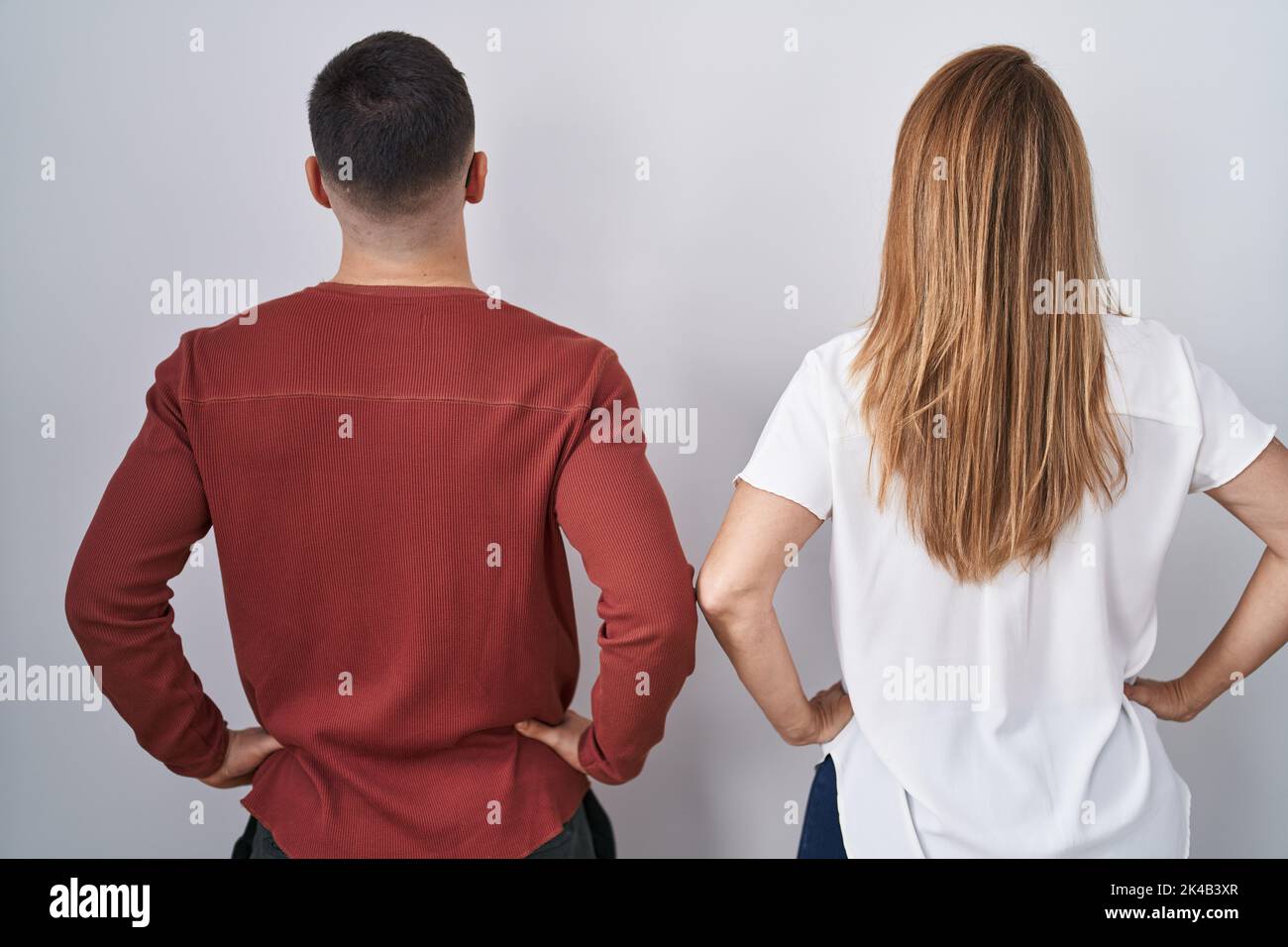 Mother and son standing together over isolated background standing ...