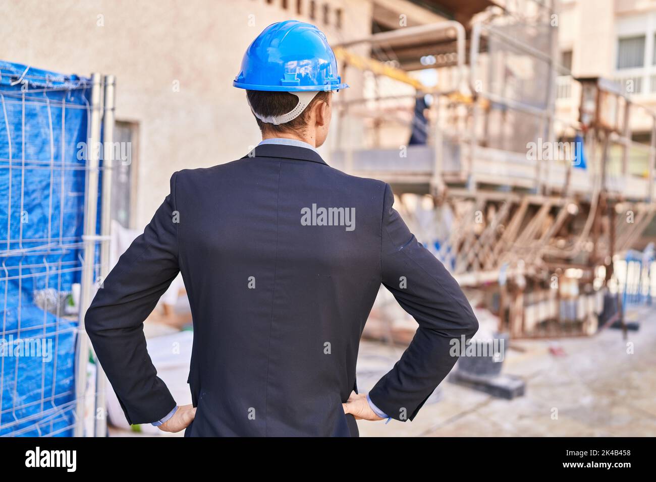 Young man architect standing on back view at street Stock Photo - Alamy
