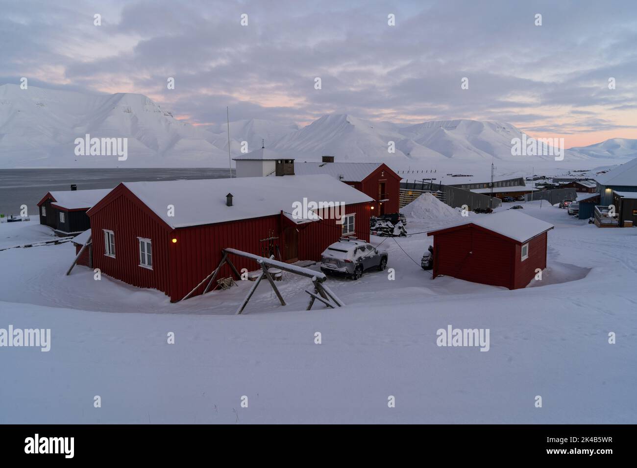 Traditional red house in snowy winter landscape of Longyearbyen ...
