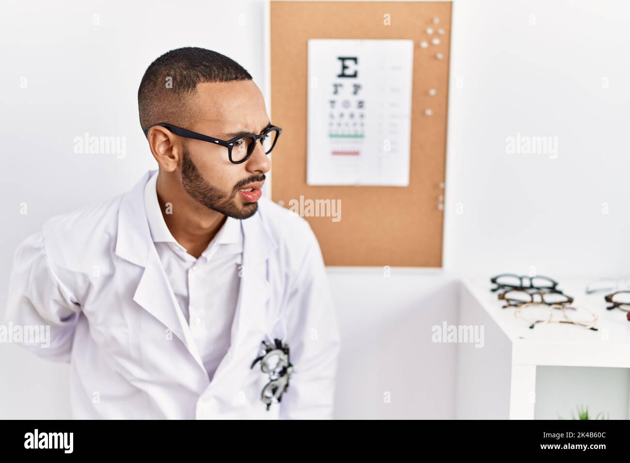 African american optician man standing by eyesight test suffering of ...
